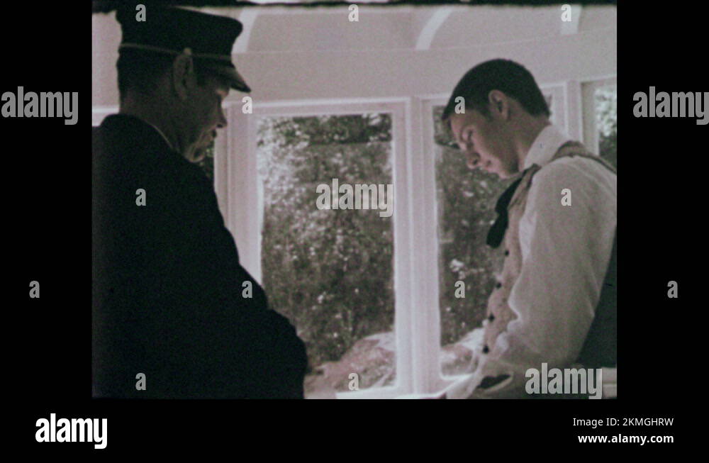 1950s: Man pointing at map another man is looking at. Man rolling map ...