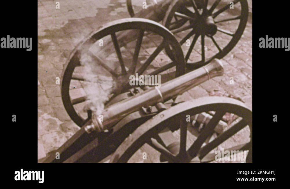 1970s: Soldiers load, fire cannons. Soldiers move cannons on street ...