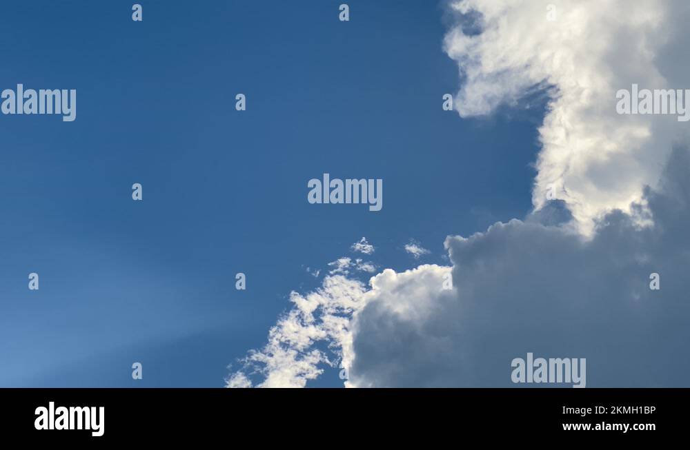 White clouds in a deep blue sky. Wide angle full circule motion, in a ...