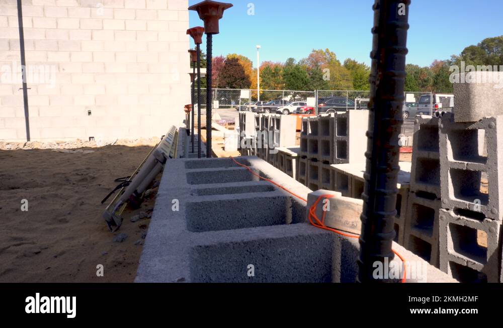 Lining up Rebar wall to add bricks and mortar Stock Video Footage - Alamy