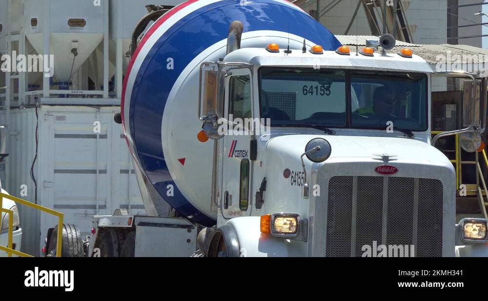 Conveyor belt pouring concrete into mixer truck at industrial cement ...
