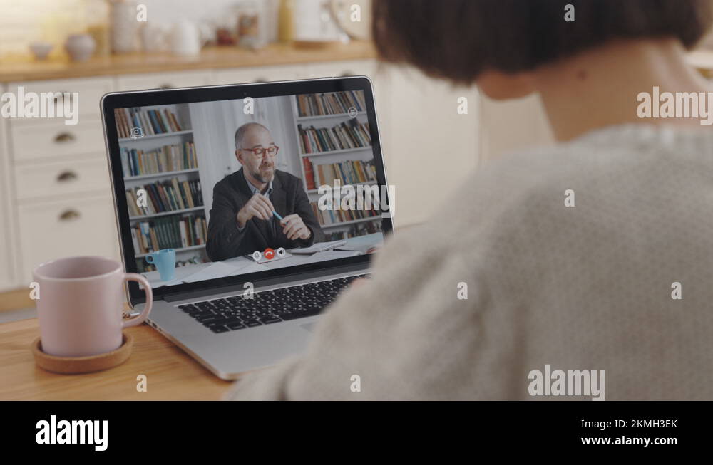 Female student having online class with teacher on laptop Stock Video ...