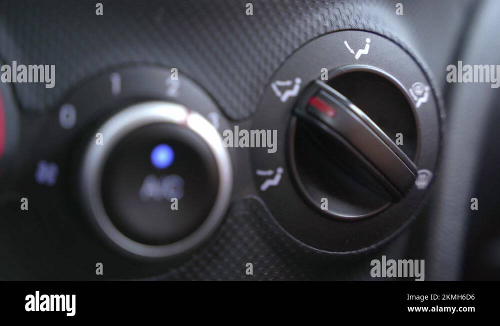 Driver turns heater lever to choose mode on dashboard in car Stock ...