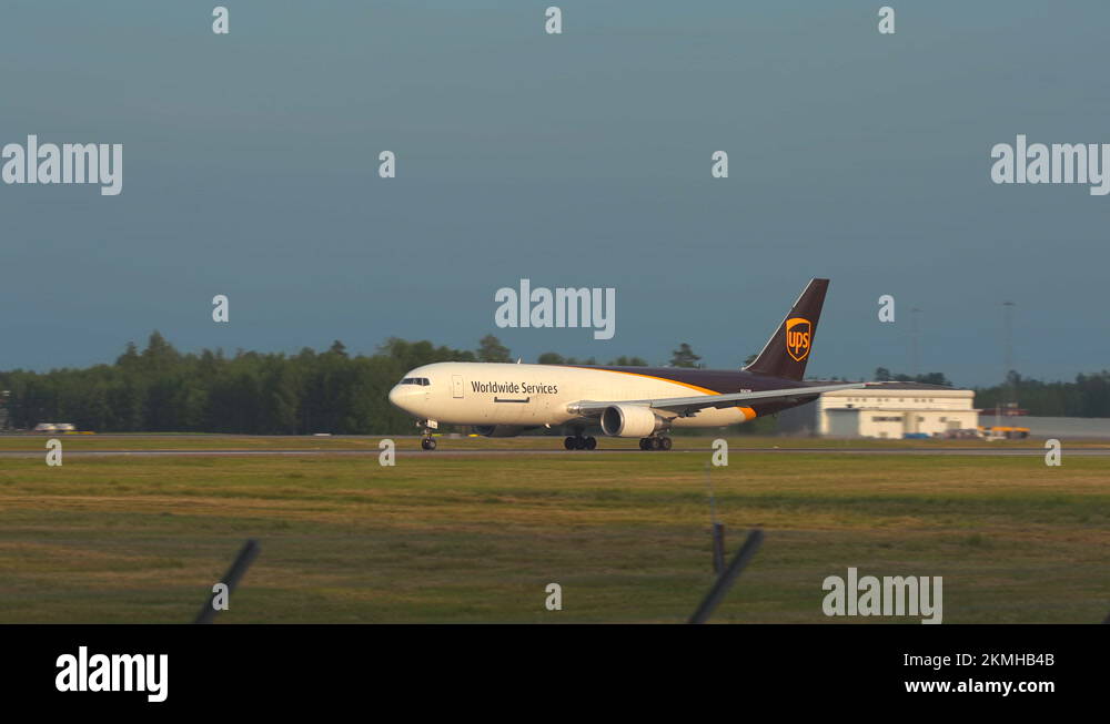 airplane ups cargo boeing 767 taking off steep climb evening light ...