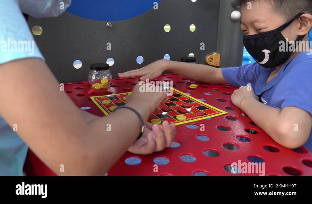 Two kids wear face mask play chess board game Stock Video Footage - Alamy