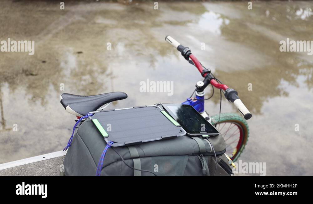 Tablet is charged from a portable solar panel battery attached to ...