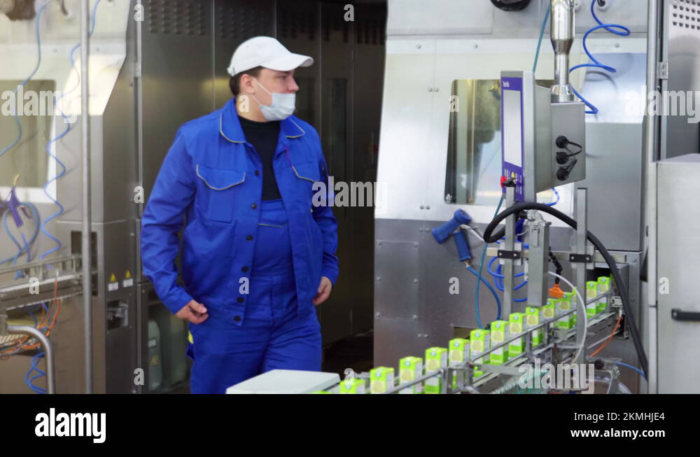 Operator Checks Data In Production Room With Milk Packs Moving On ...