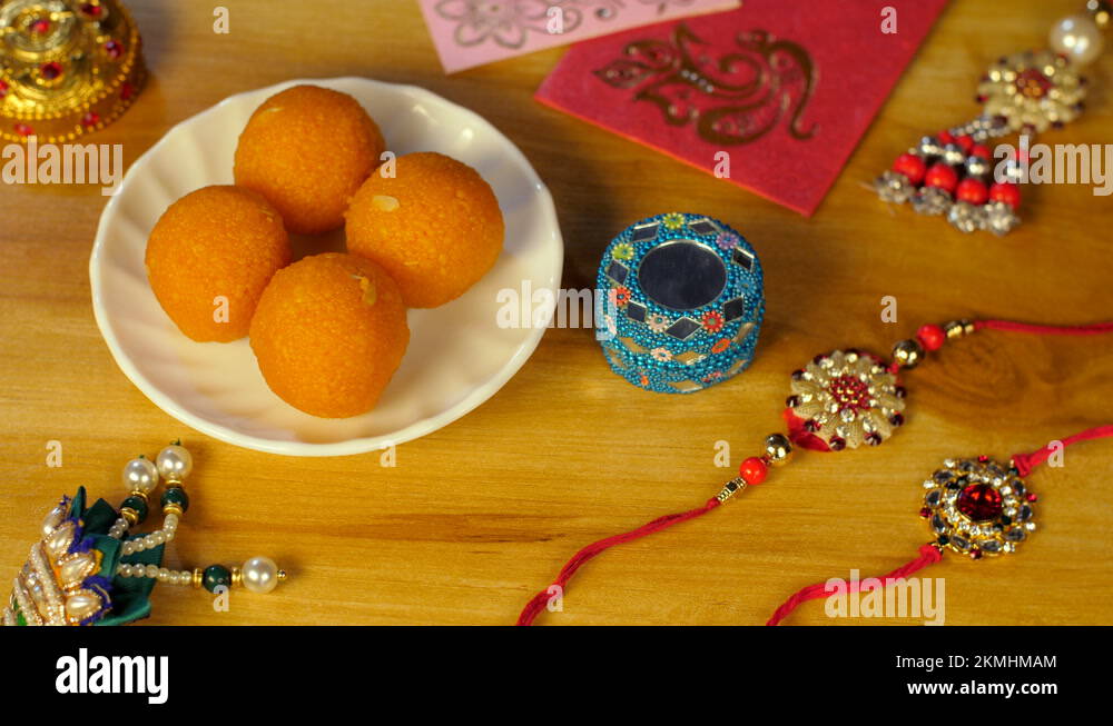 A lady is eating an Indian traditional sweet / Laddu on Raksha Bandhan ...