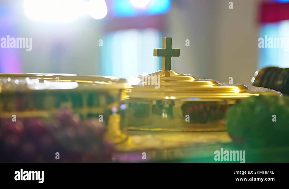 Christian Communion Ceremony, rotating shot of a golden cross on top of ...