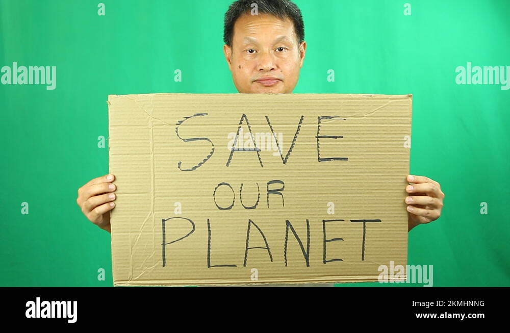 Man holding a sign Save our planet word , green screen in studio ...