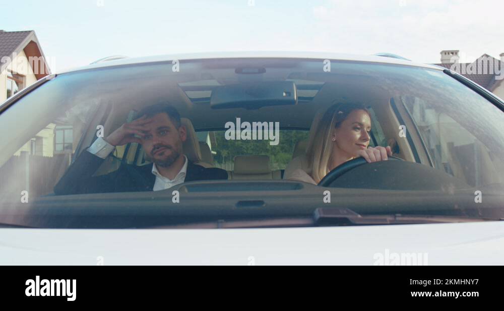 Romantic couple of travelers driving at the car together while going on ...