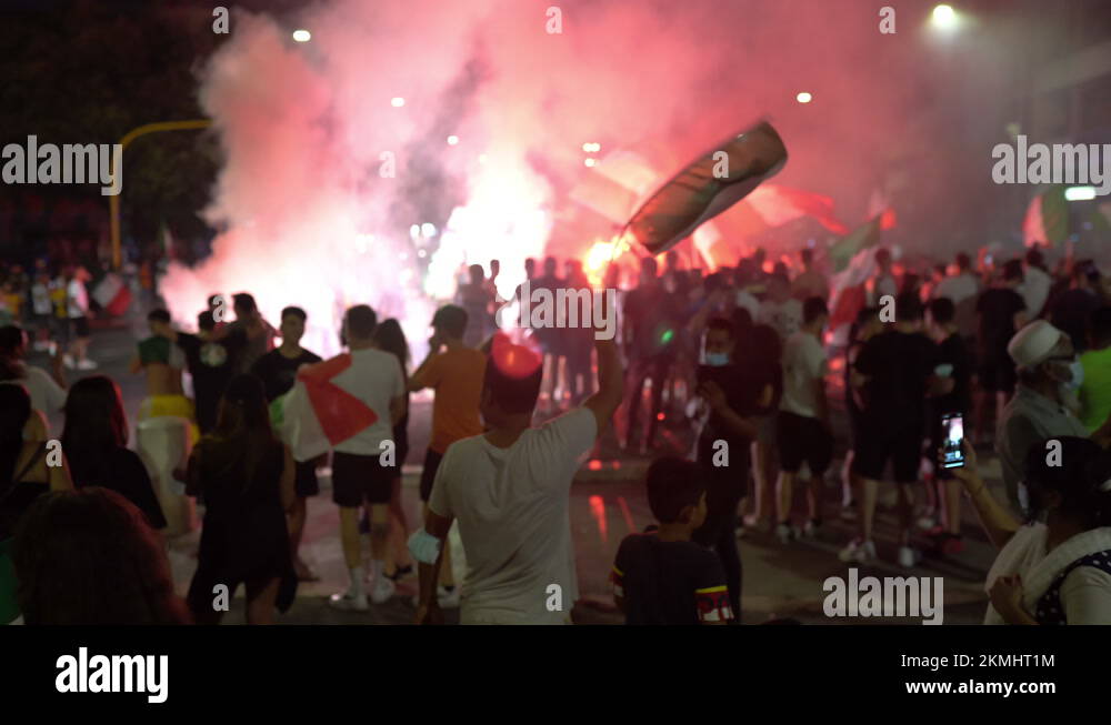 ROME, ITALY - JULY 11, 2021: Italian street hooligans burning red smoke ...