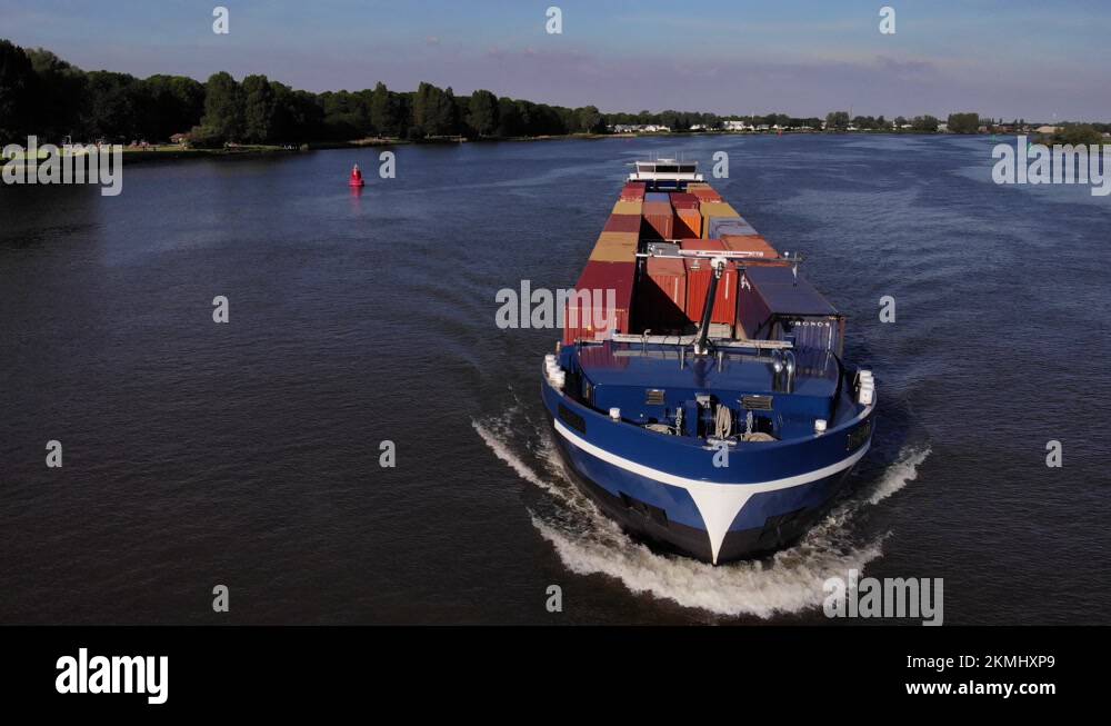 Trading Vessel Loaded By Intermodal Containers Moving On Oude Maas ...