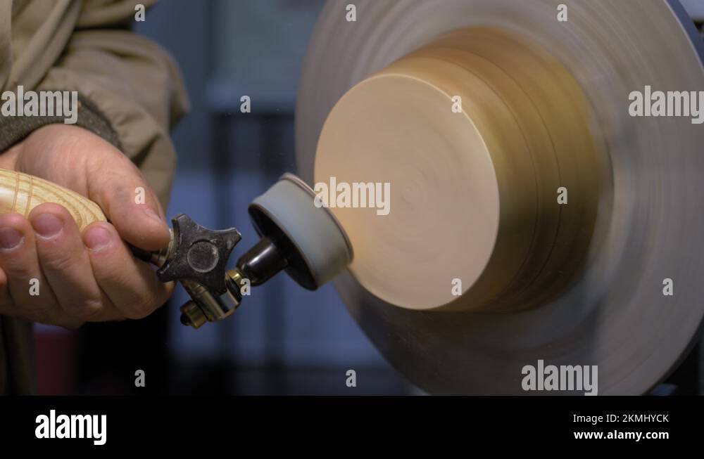 Man carpenter using hand rotary tool, polishing wood product: slow mo ...