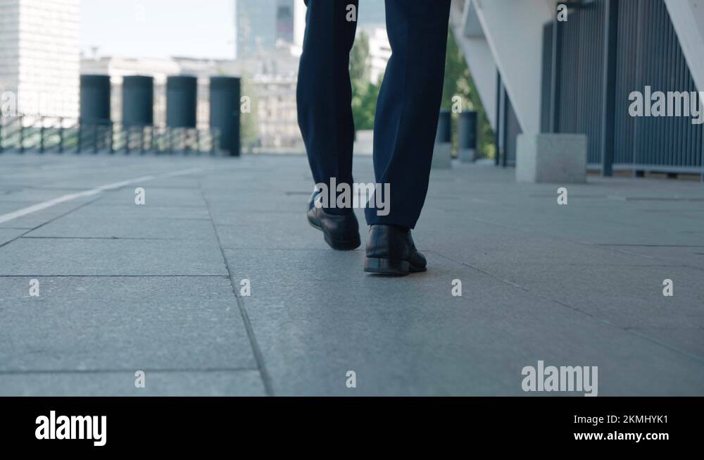 Rear back view feet of businessman commuting to work. Confident man in ...