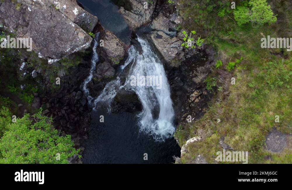 Rotating bird's eye view of waterfall through rock formations - Fairy ...