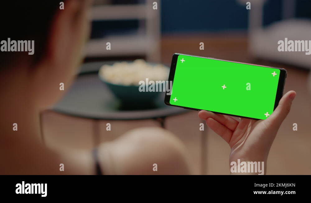 Close up of mobile phone with horizontal green screen on display Stock Video Footage - Alamy