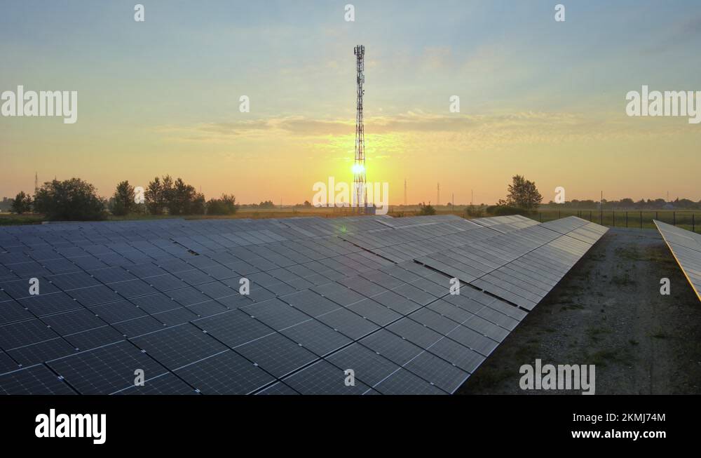 Sliding side view of photovoltaic solar panels at solar farm during ...