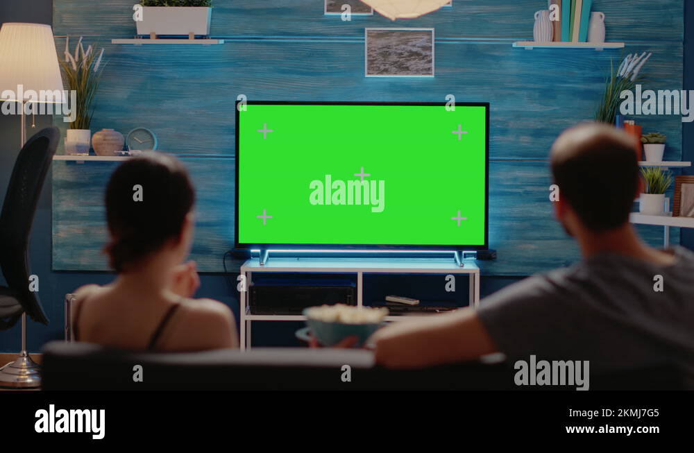 Young man and woman watching green screen on tv display Stock Video ...