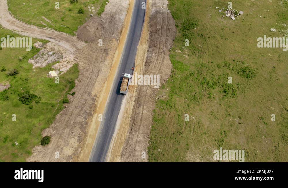 Sand is poured out of body of powerful mining dump truck for ...