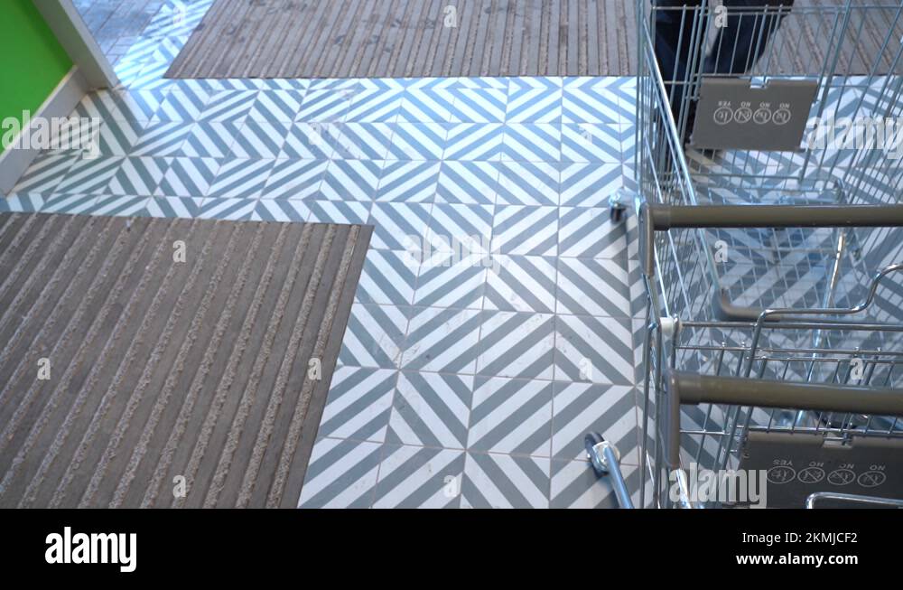 The customer takes a trolley from the row Stock Video Footage - Alamy