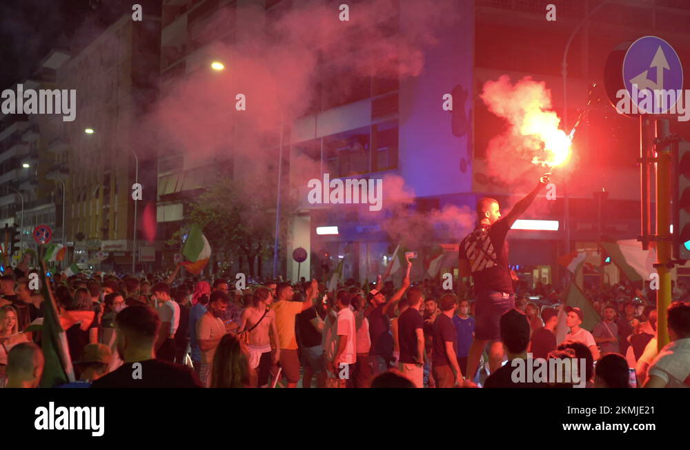 ROME, ITALY - JULY 11, 2021: Italian street hooligans burning red smoke ...