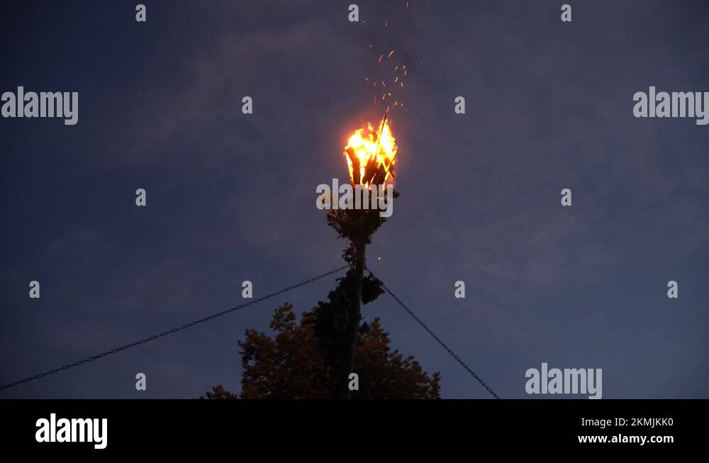 Midsummer A Latvian man with an oak leaf wreath lighting up a pūdele (a ...