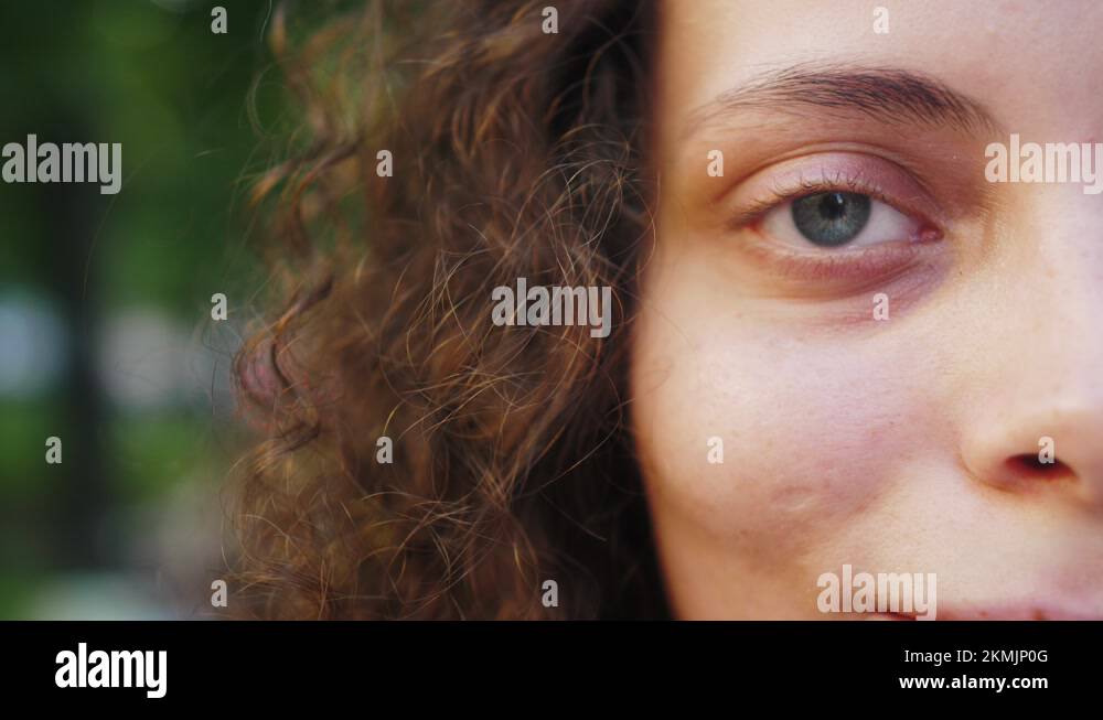 Close-up half face Jewish teen girl with curly hairstyle, big blue eyes ...