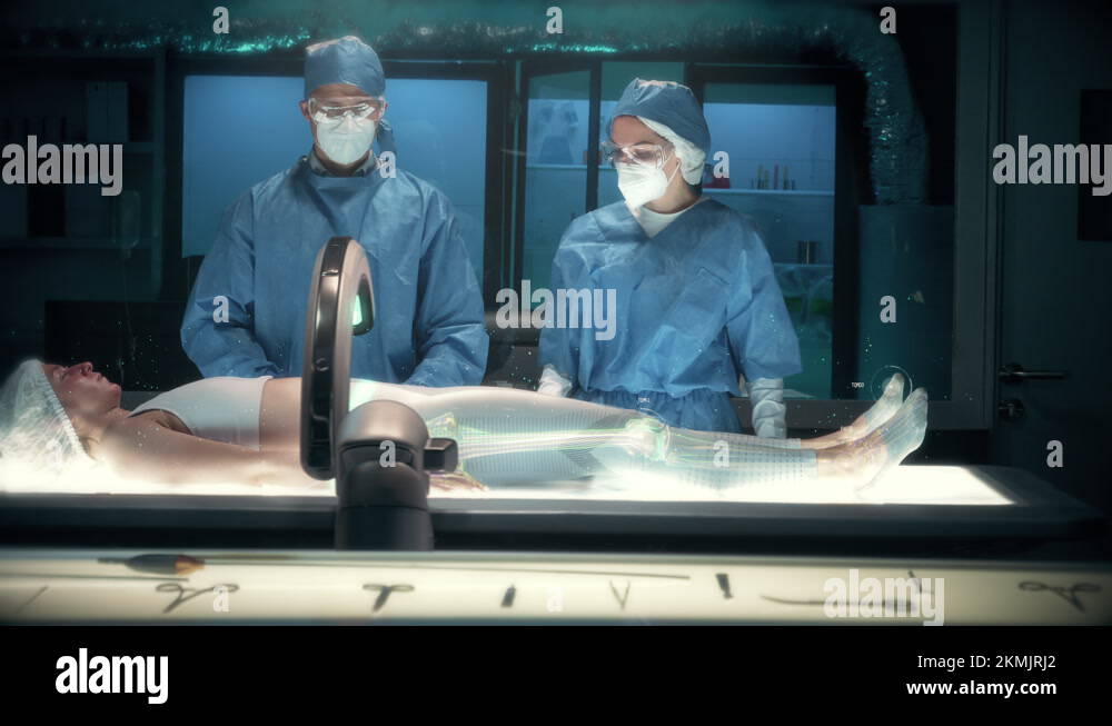 Team of surgeons use a futuristic body anatomy scanner on female ...