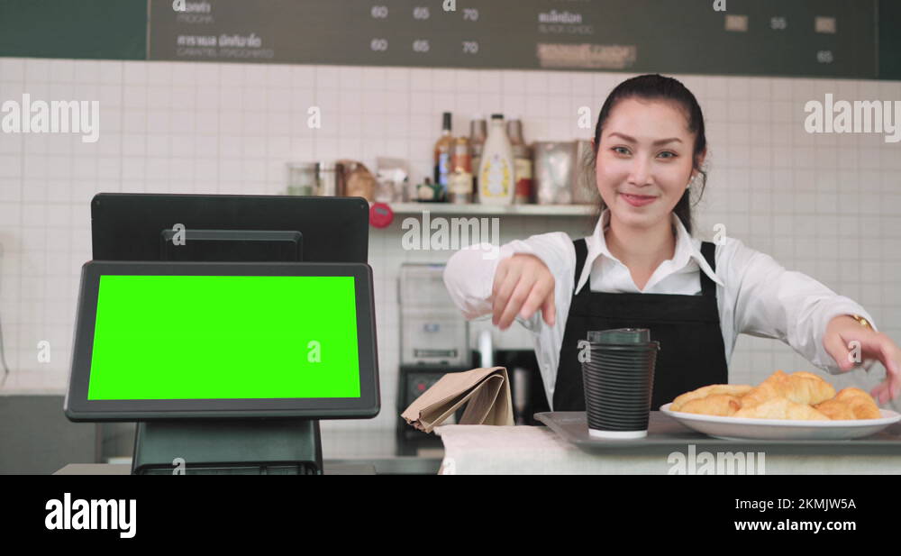 Touch screen cashier machine with blank green screen at modern coffee ...