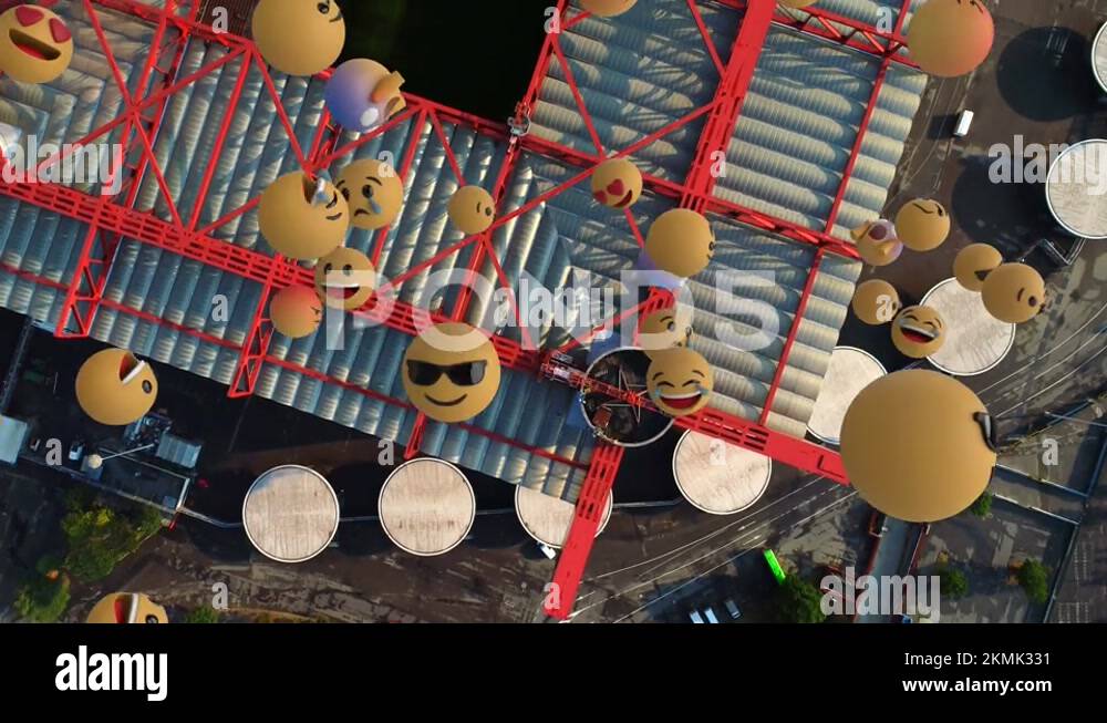 Digital composition of multiple face emojis floating against aerial ...