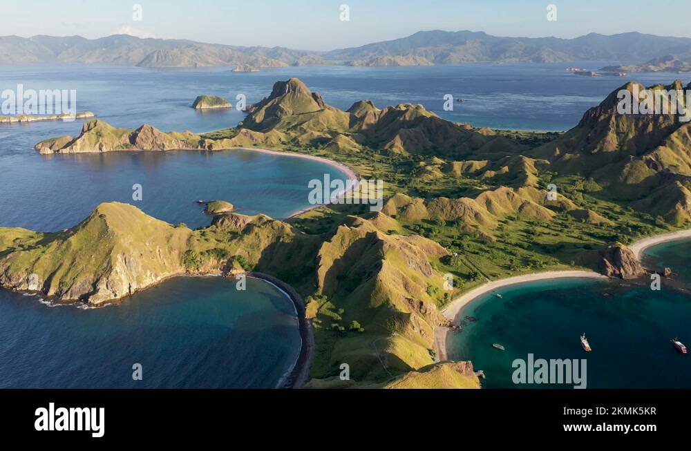 Padar island Indonesia bays panorama with tour boats right and Komodo ...
