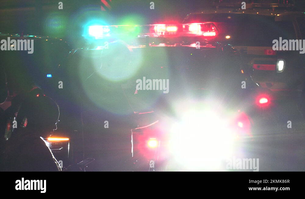 Multiple police cars at night with emergency lights flashing at crime ...