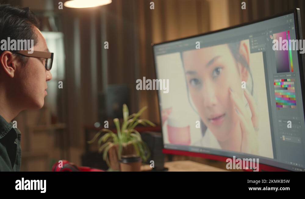 Asian Male Digital Editor Drinking Coffee While Works In Photo Editing ...