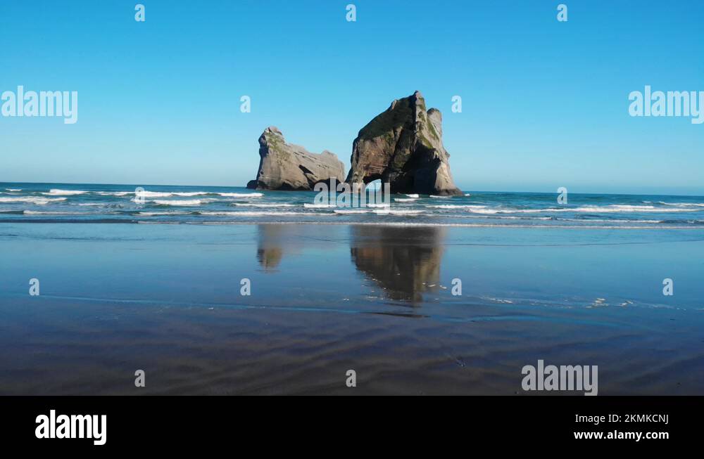 Beautiful scene of rock archway, view from sandy beach. Popular spot in ...