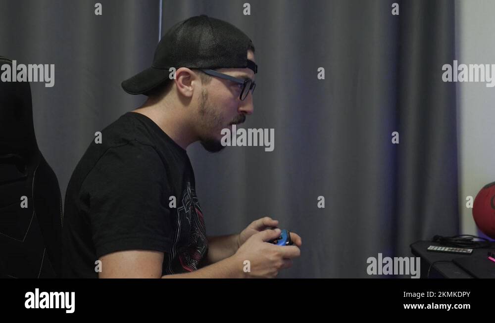 Gamer playing games on the PC with a controller a full RGB Setup FullHD ...