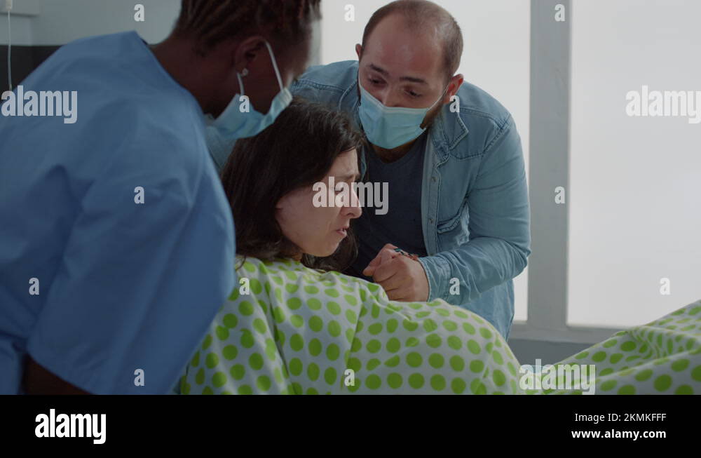 Young woman in labor giving birth to baby in hospital ward Stock Video ...