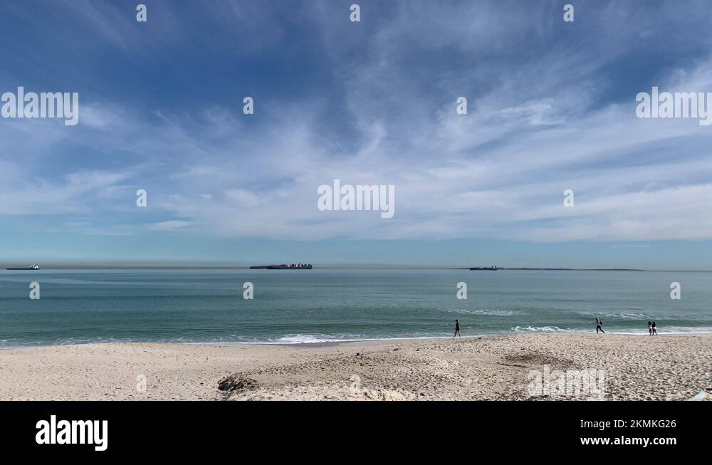 Container Ships in Table Bay Cape Town people walking on the beach ...