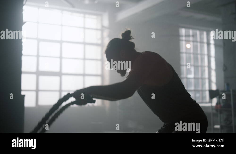 Man doing crossfit workout with battle ropes. Angry guy training body ...