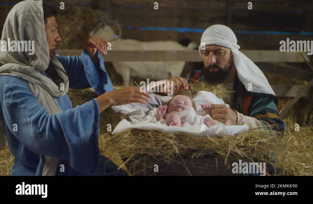 Mary and Joseph taking care of baby Jesus in inn stable Stock Video ...