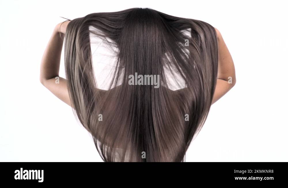 Woman moves long hair. Rear view. Girl shakes long straight hair ...