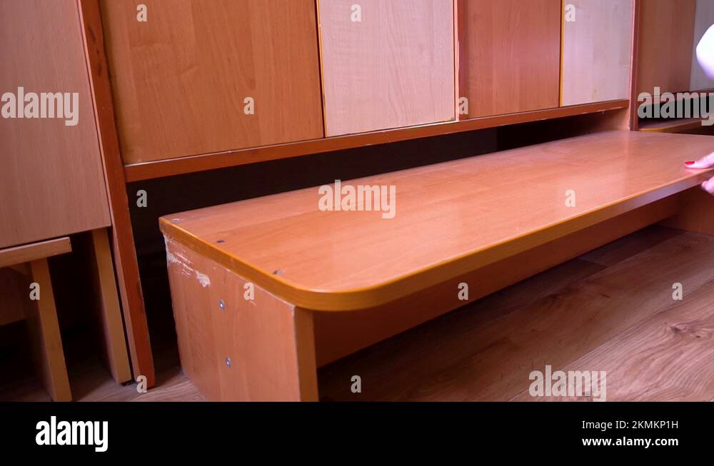 Opening a locker in a dressing room, a hand pulls out a dressing room ...