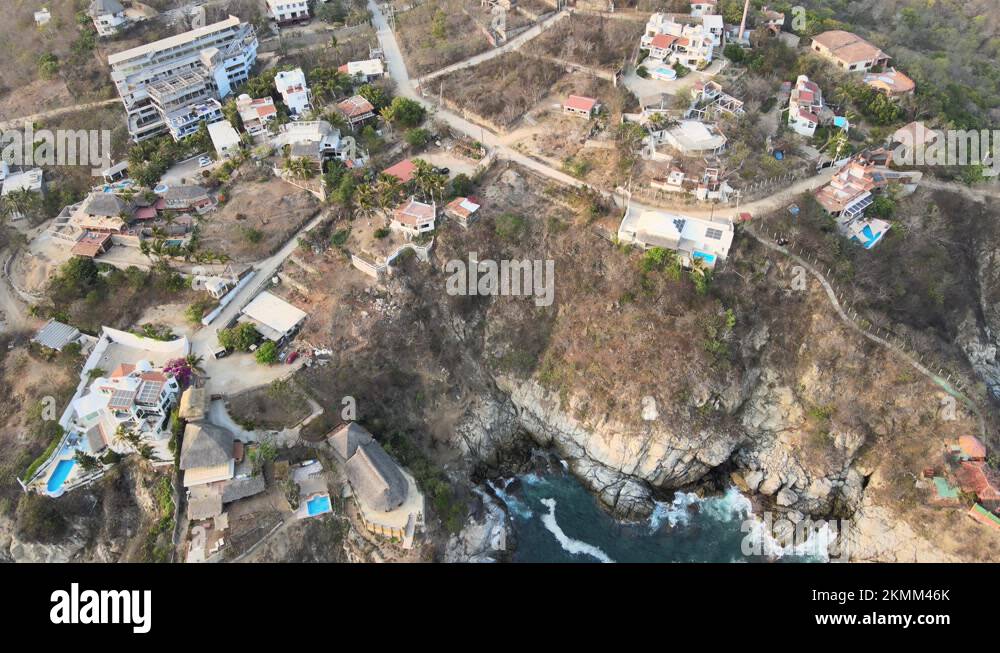 Pull front view of the small town Puerto Angel on the side of the cliff ...