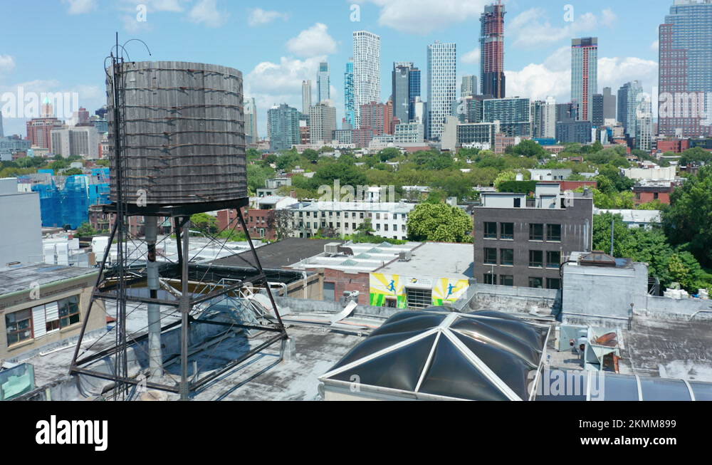 flying past iconic roof top water tank towards downtown Brooklyn ...