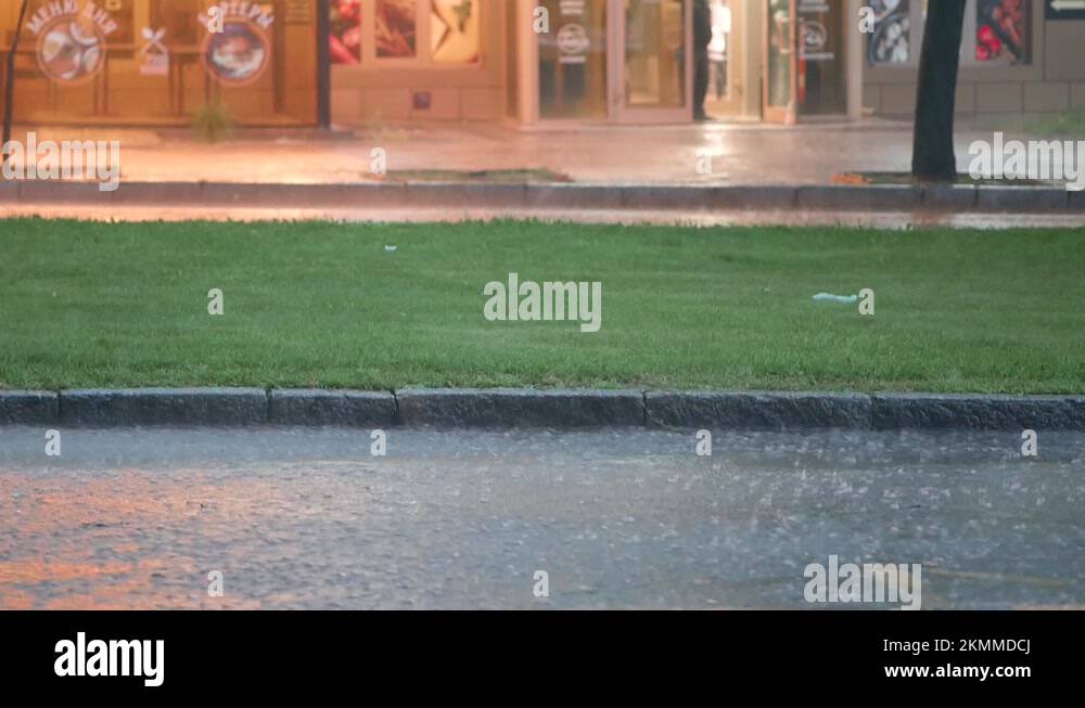 Hurricane downpour on a city street. Heavy rain with wind and a lot of ...