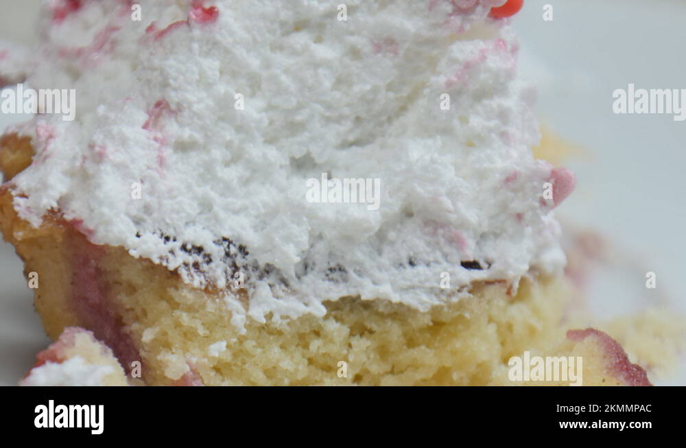 in detail. A small white ceramic spoon takes a piece of the creamy ...