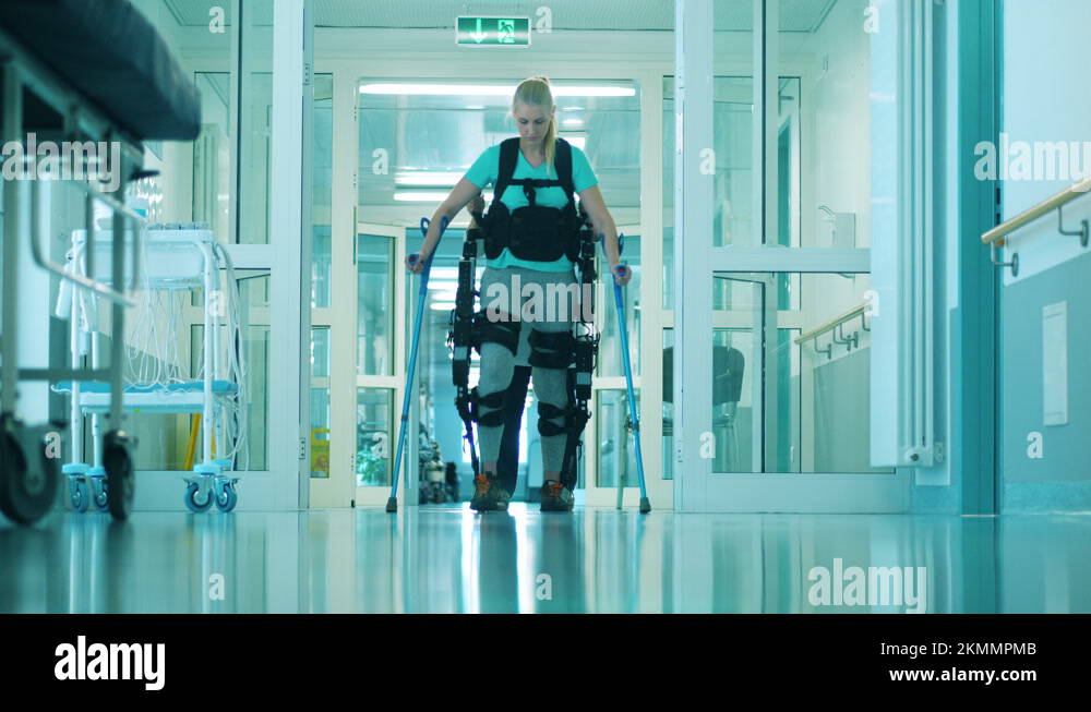 Disabled woman in the exoskeleton is walking with crutches Stock Video ...