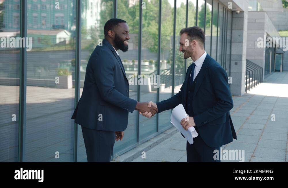 Two business men shake hands when meeting, agree to a deal or say hello ...