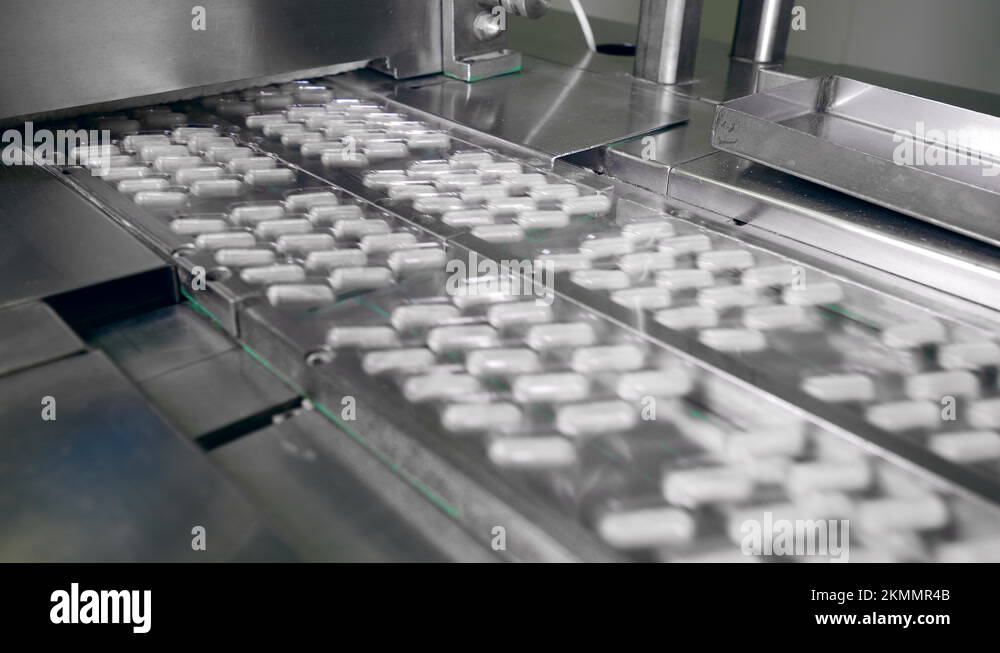 Batches of capsule meds are getting relocated by a conveyor Stock Video ...