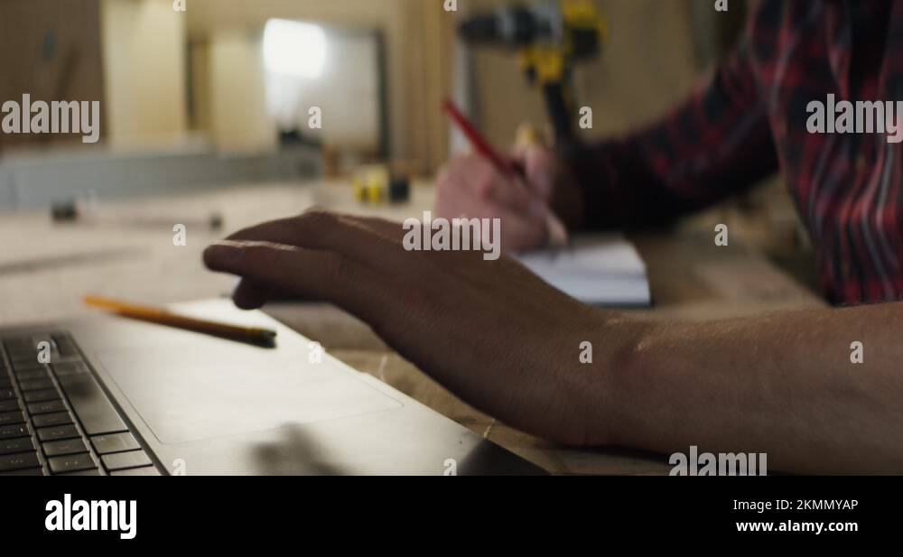 man makes a pencil drawing in a notebook using a ruler close-up Stock ...